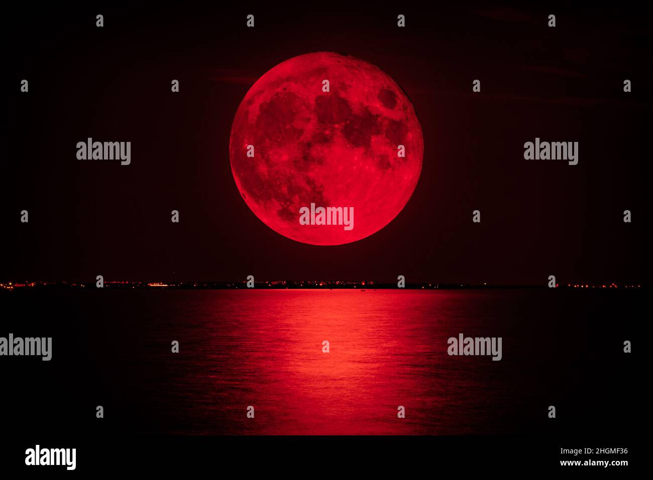 Full red moon over the sea Stock Photo - Alamy