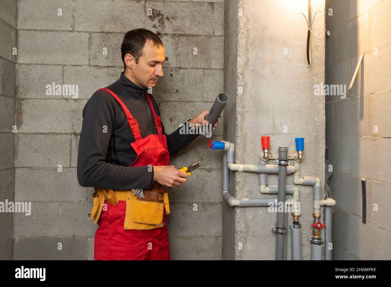 building, profession and people concept - builder or plumber working ...