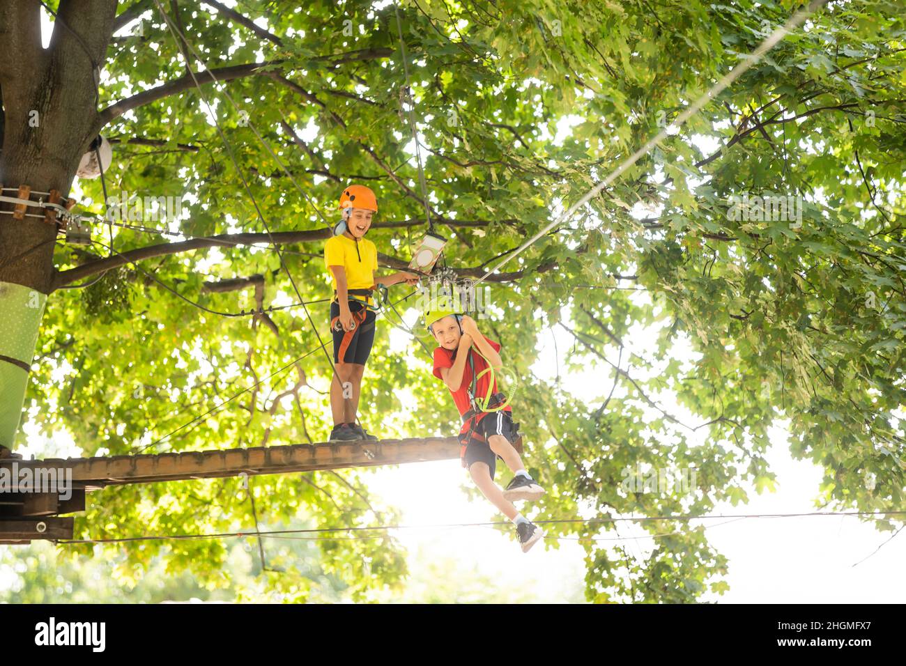 Happy child climbing in the trees. Rope park. Climber child. Early ...