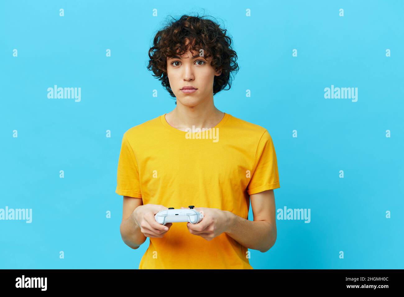 curly guy in plays games gamepad technologies Stock Photo - Alamy