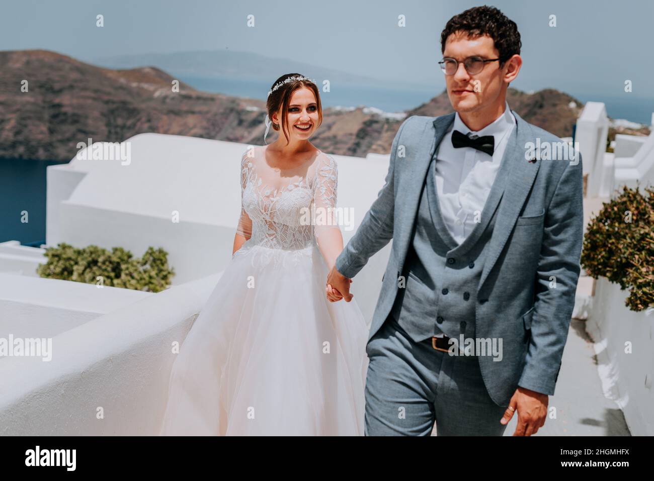 beautiful bride and groom in their summer wedding day on greek island ...