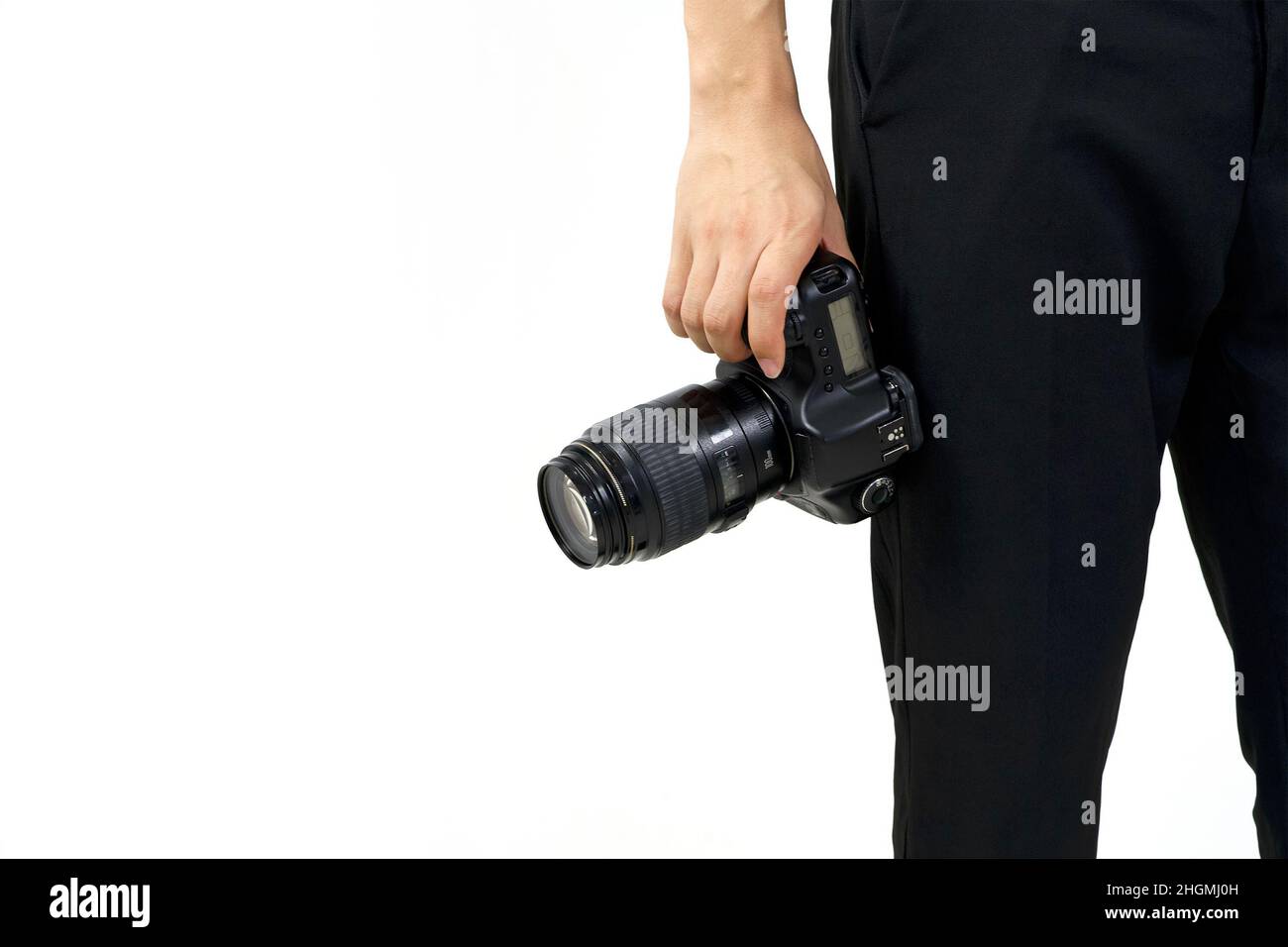 The photographer holds the camera by hand in the hip position Stock ...