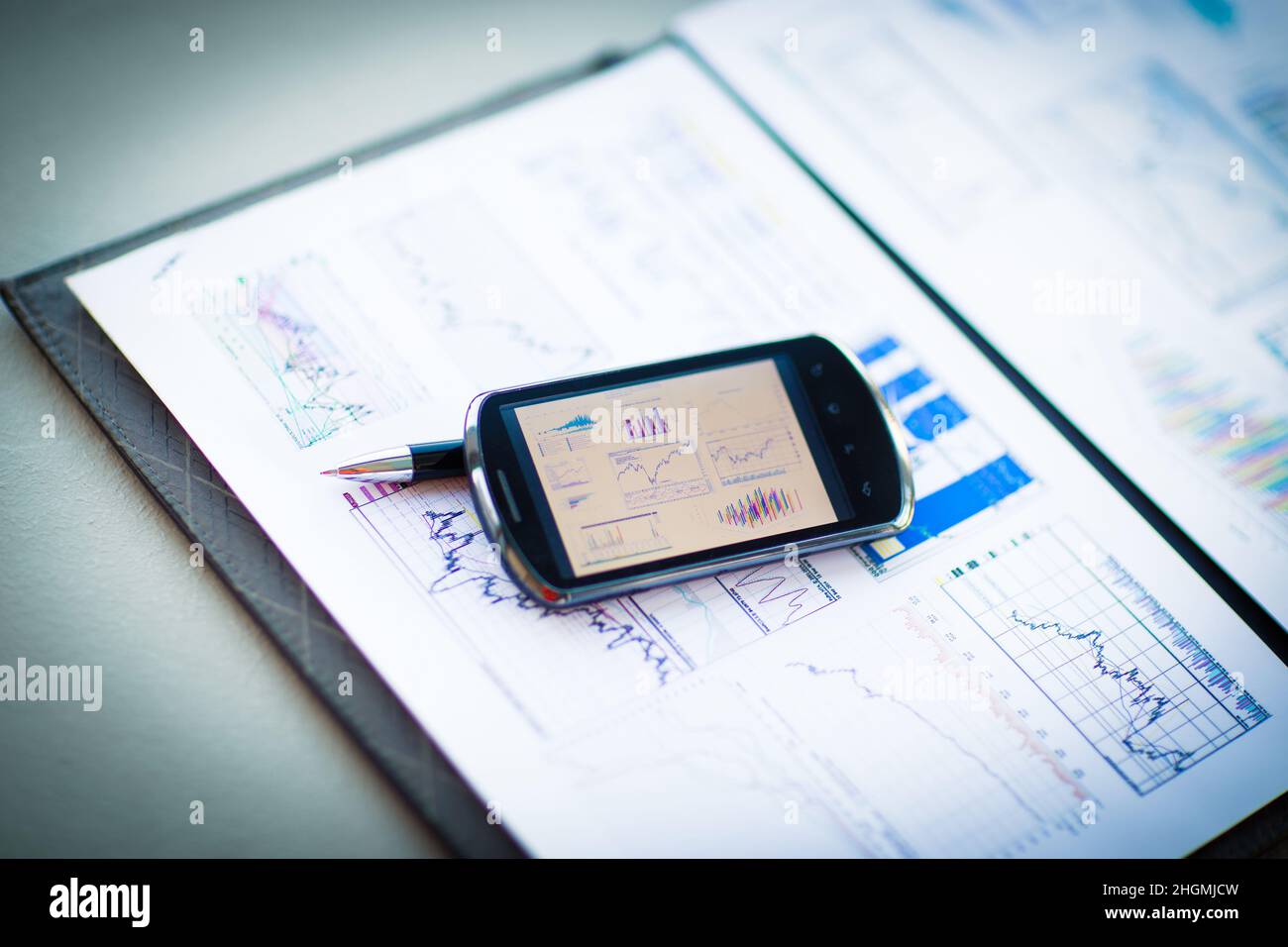 Business chart with smart phone Stock Photo - Alamy
