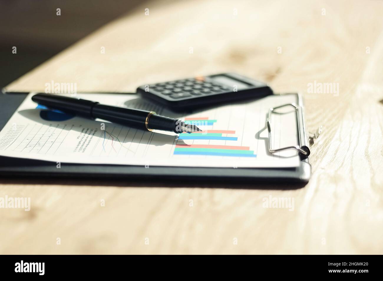 pen, calculator and financial graph on a workplace of the businessman ...