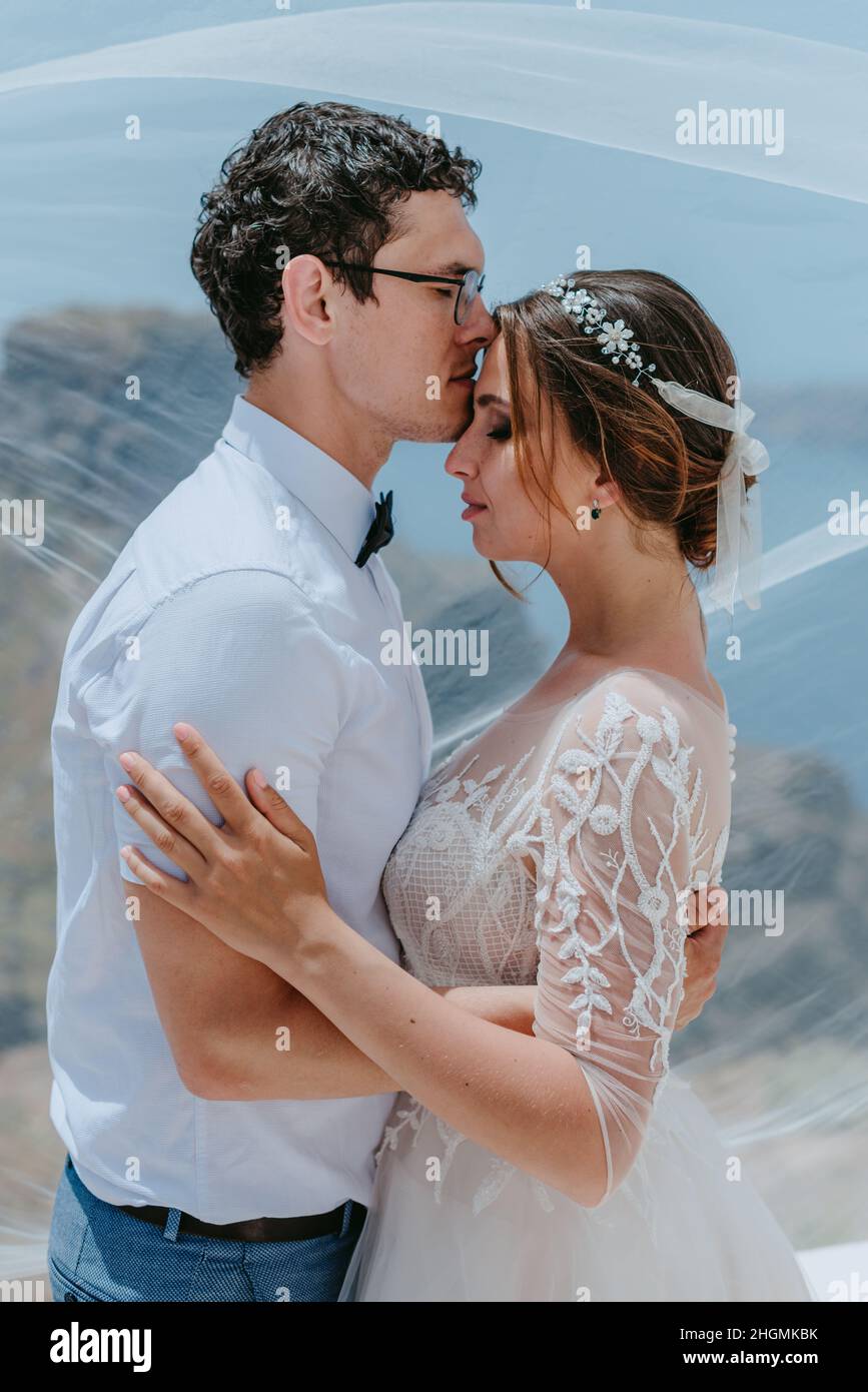 beautiful bride and groom in their summer wedding day on greek island ...