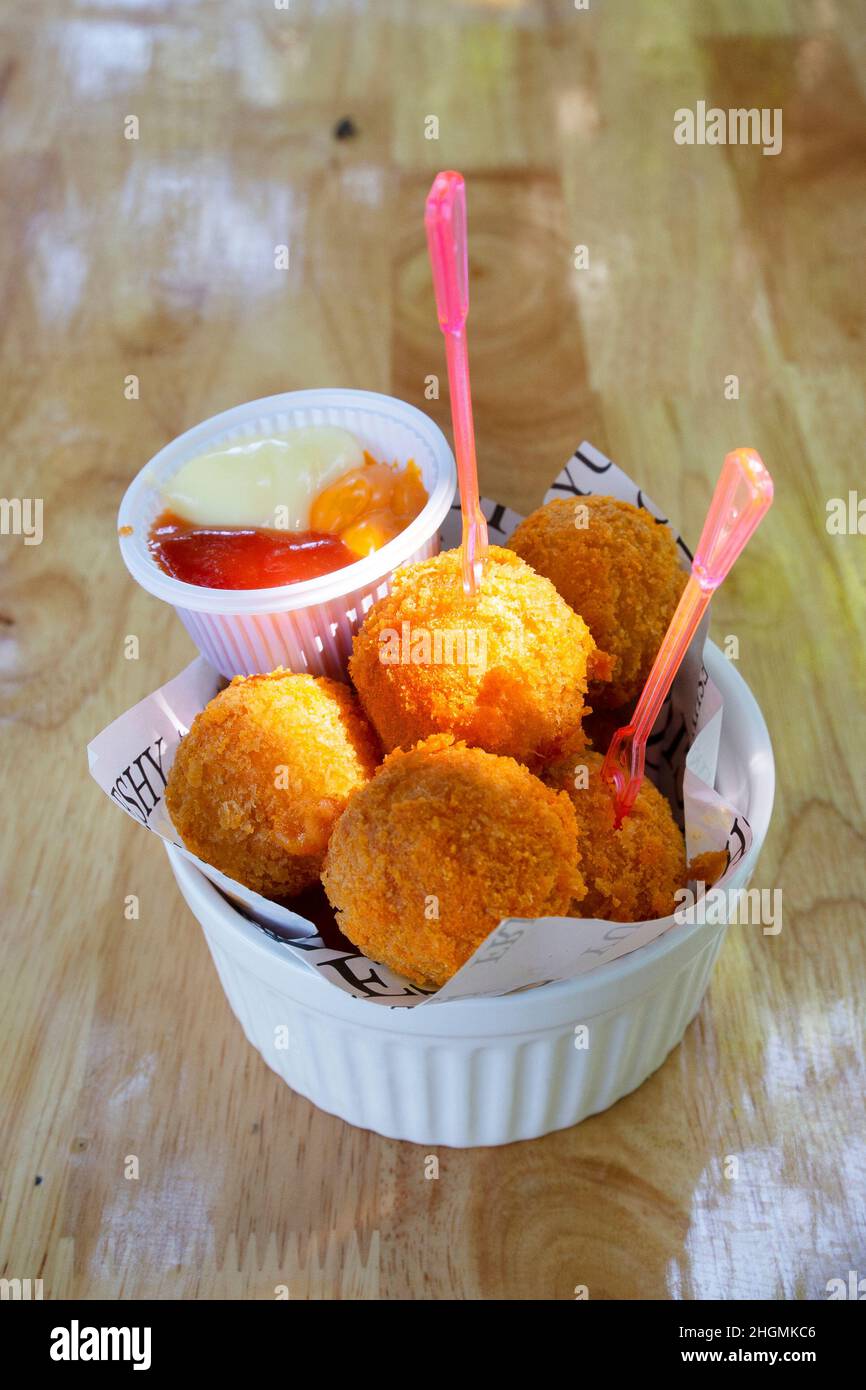 Cheese balls are served ready to eat in small white ceramic cup Stock ...