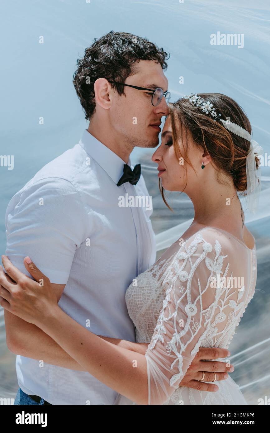 beautiful bride and groom in their summer wedding day on greek island ...