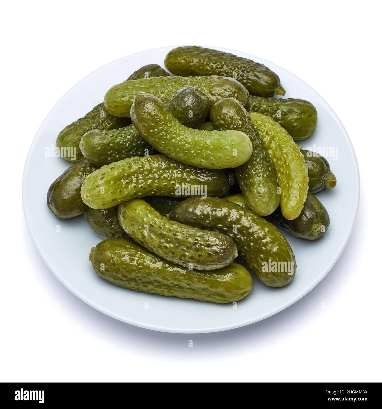 Plate of Tasty canned Whole green cornichons isolated on a white ...