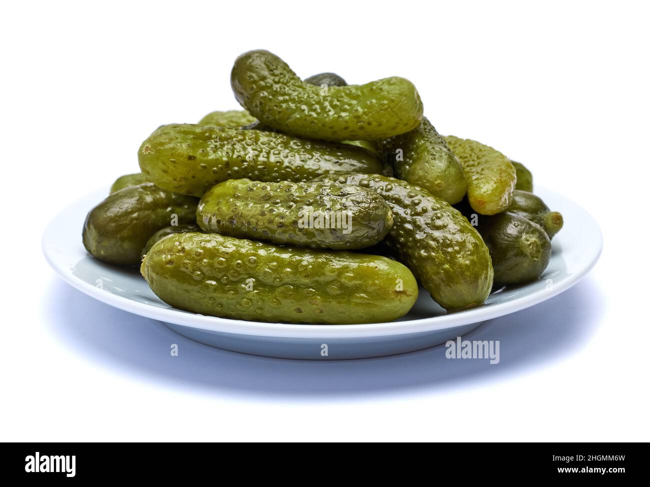 Plate of Tasty canned Whole green cornichons isolated on a white ...