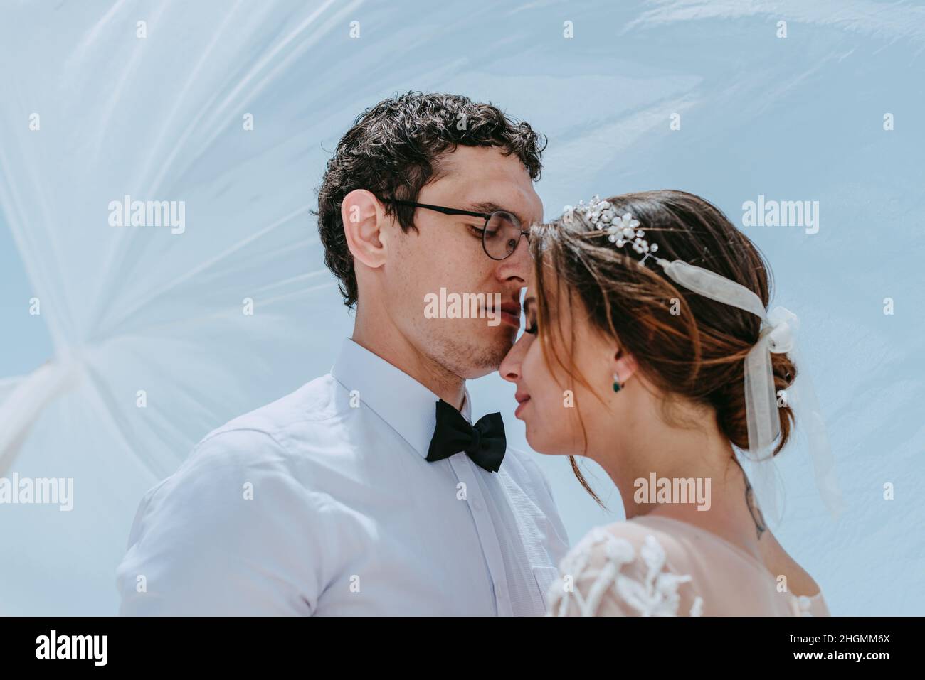 beautiful bride and groom in their summer wedding day on greek island ...