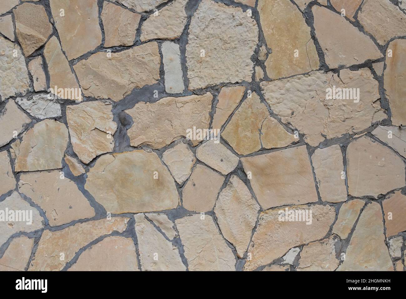 The antique wall is paved with gray stones, top view. stone texture ...
