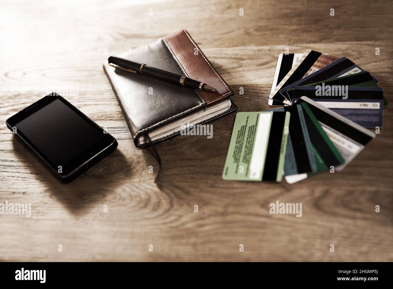 mobile phone, pen, Notepad and a Bank Stock Photo - Alamy