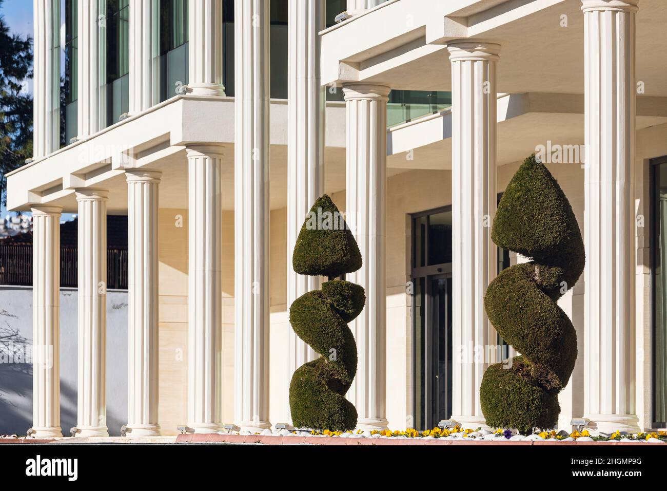 Beautiful white building in antique style made of stone with columns ...
