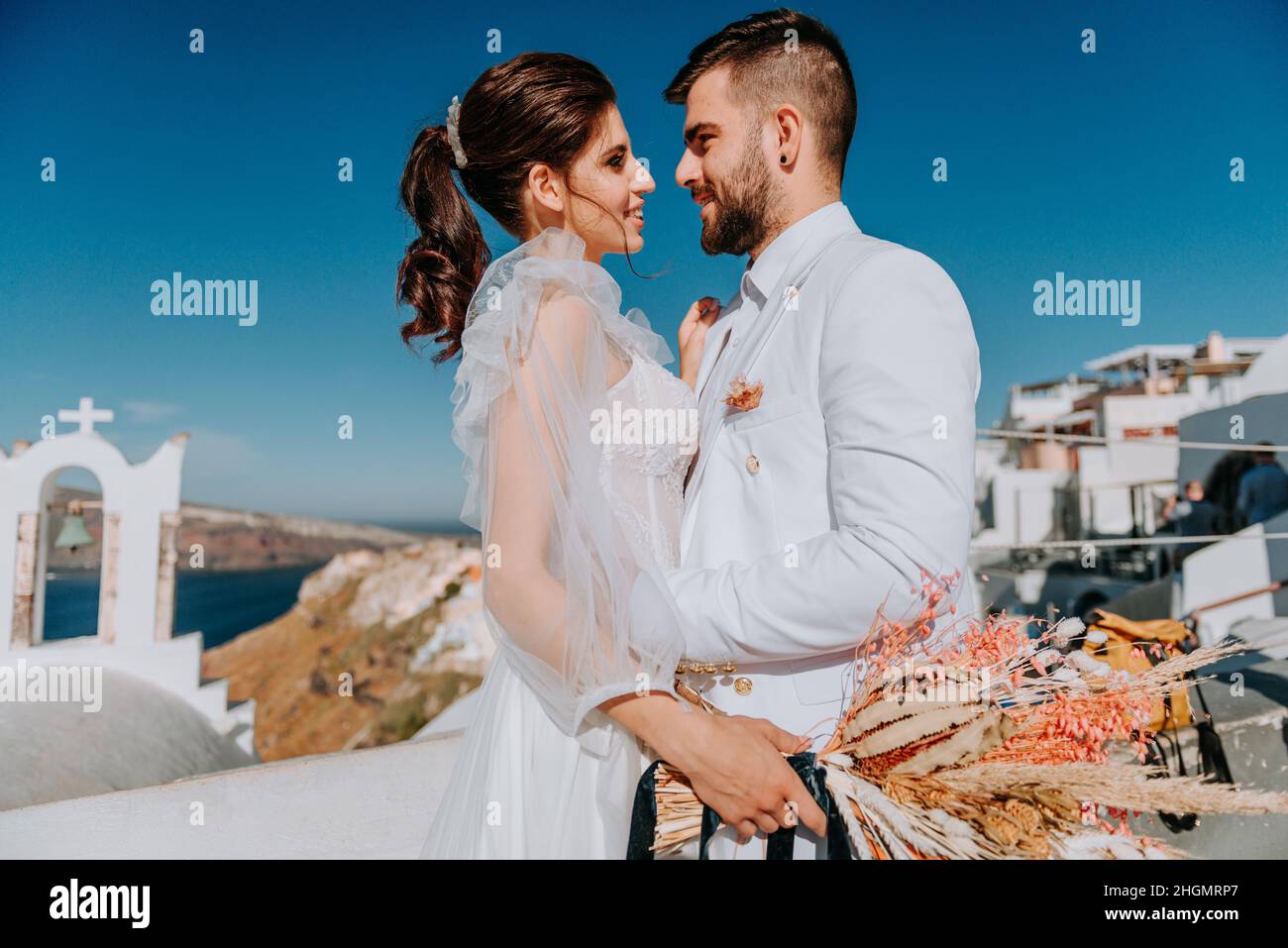 beautiful bride and groom in their summer wedding day on greek island ...