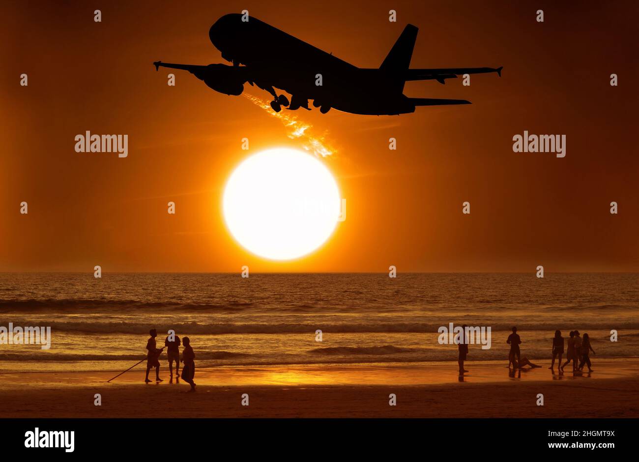 Aircraft Take Off And The Sunset And People On The Beach Stock Photo aircraft-take-off-and-the-sunset-and-people-on-the-beach-stock-photo