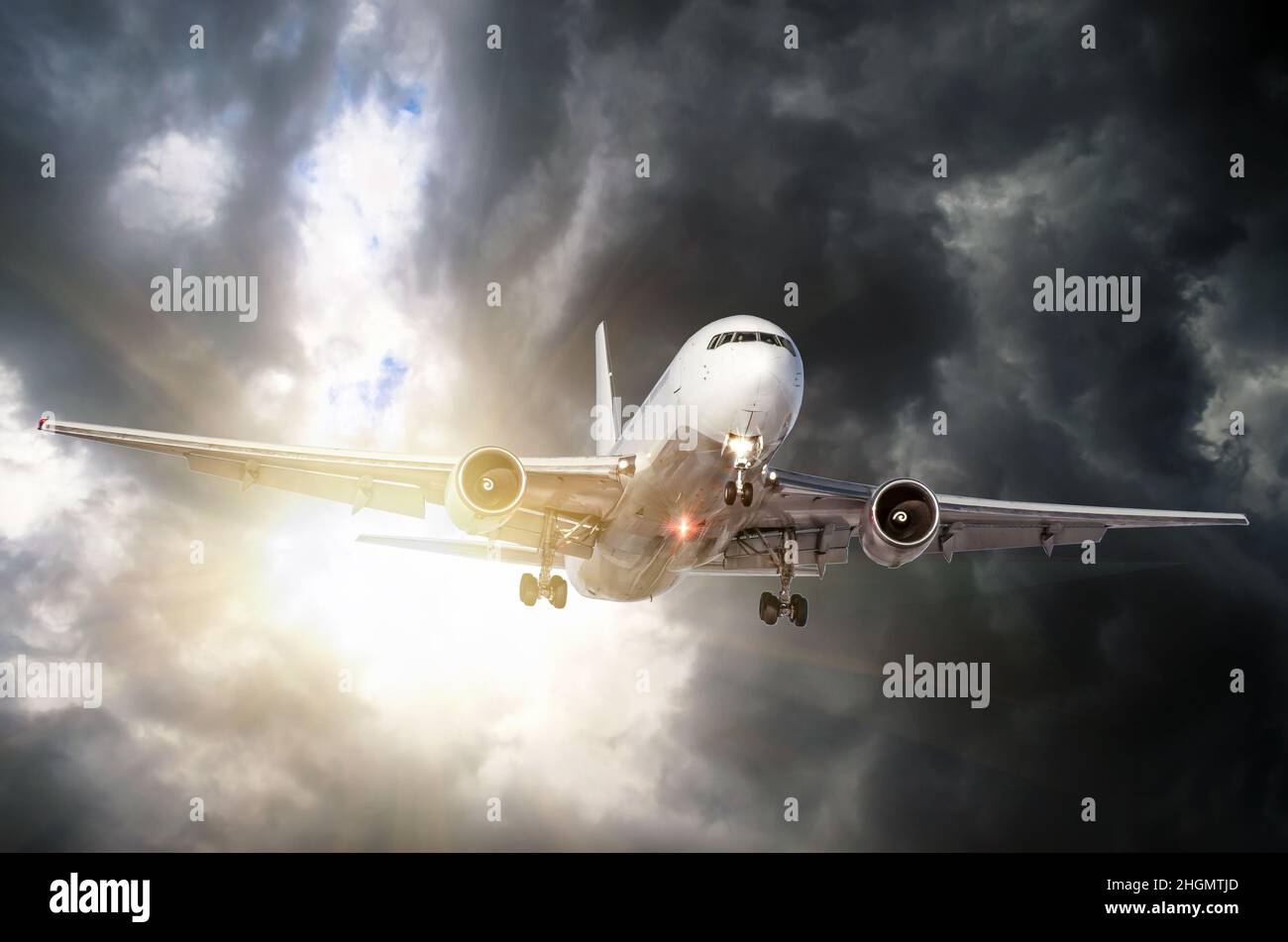 Passenger airplane departs from the dark storm clouds in bad weather on ...