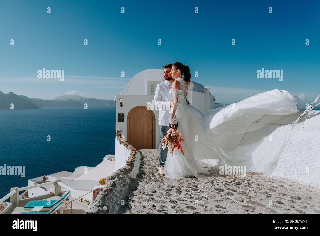 beautiful bride and groom in their summer wedding day on greek island ...