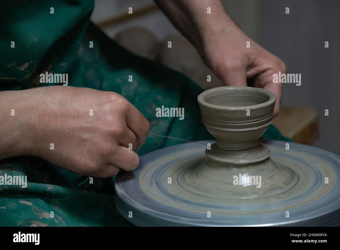 Craft hands making a clay pot. Men's hands. Potter at work. Creating ...