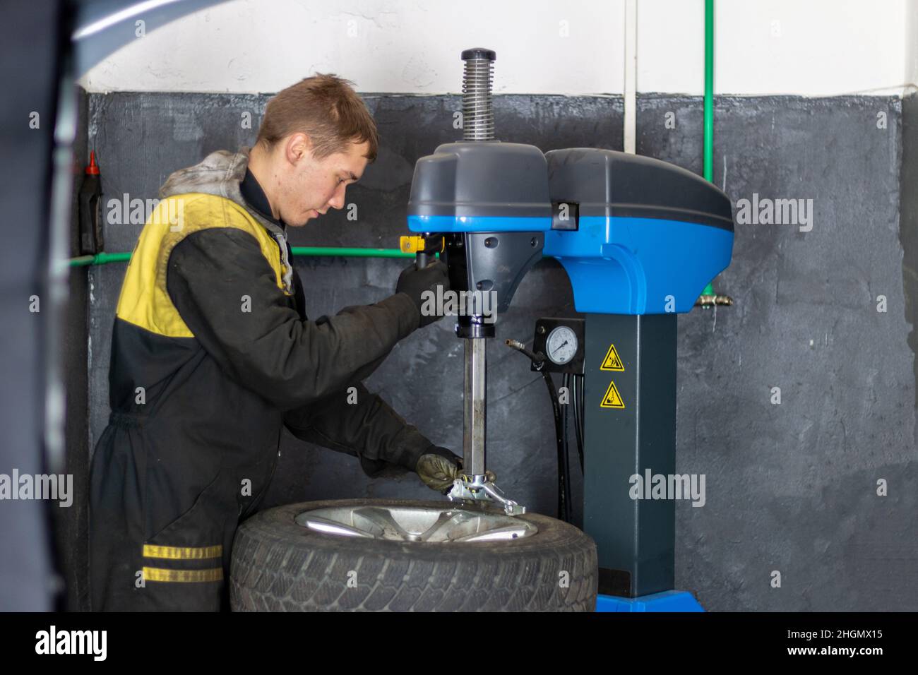 Car master mechanic vulcanizer repairing tire on automatic rubber ...