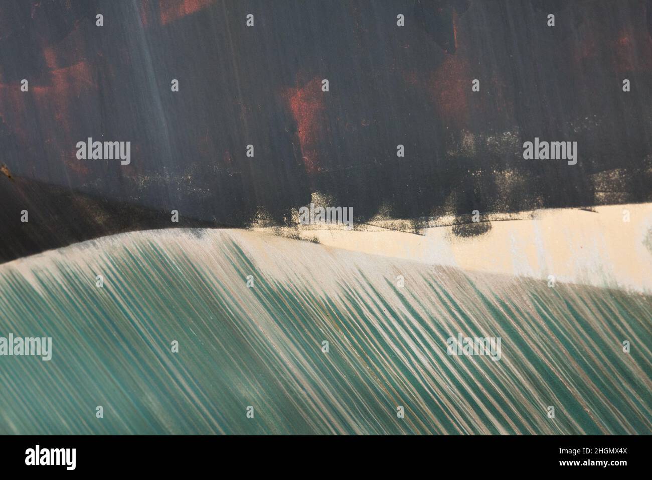 Brightly coloured paint work and salt lines on the hull of a fishing ...