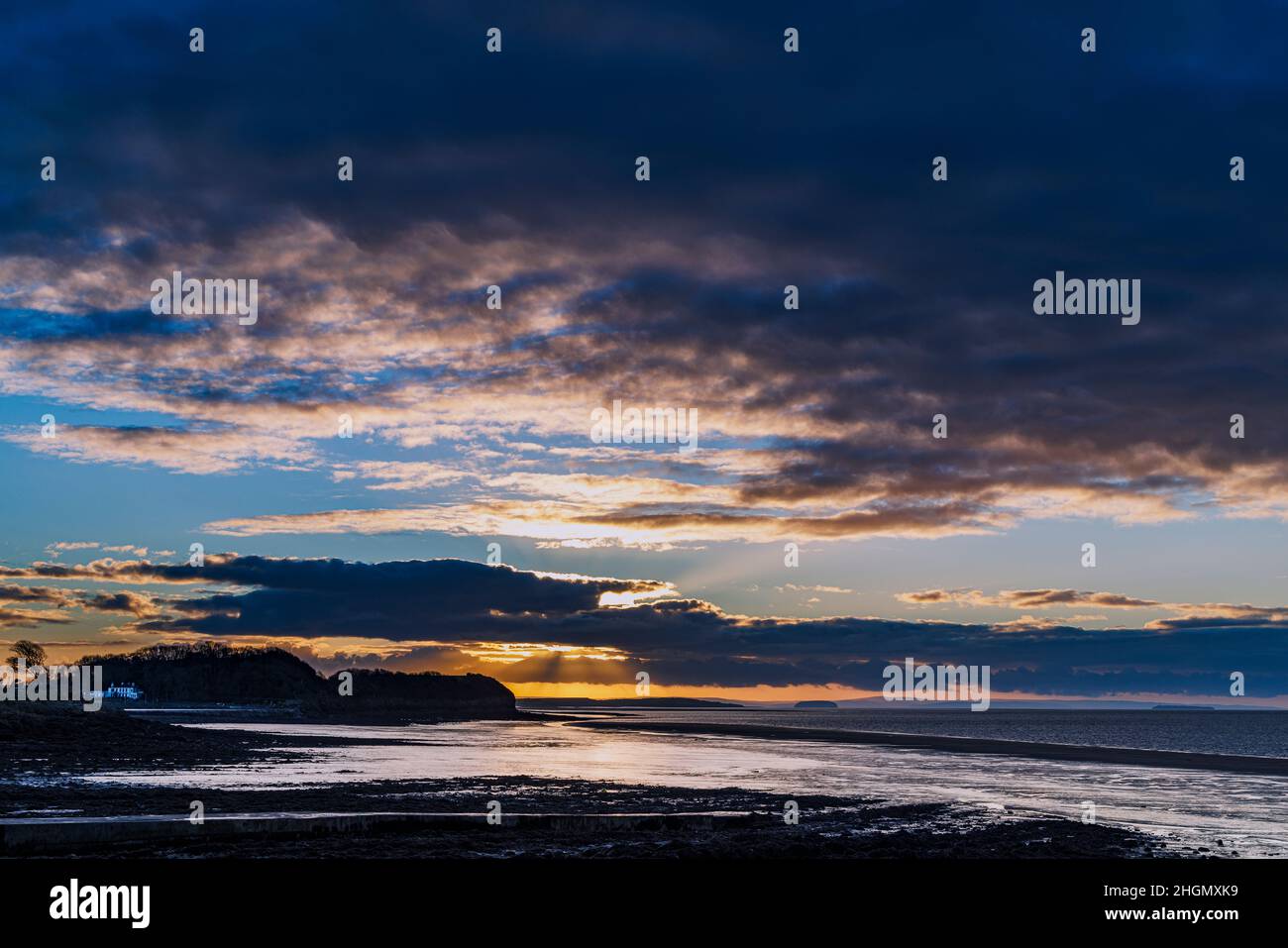 The setting sun lighting up the cloud cover Stock Photo - Alamy