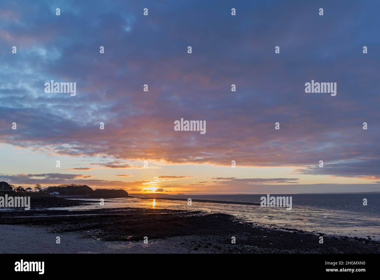 The setting sun lighting up the cloud cover Stock Photo - Alamy