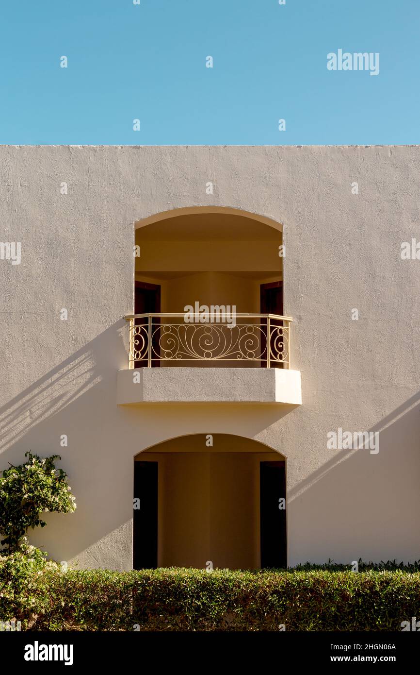 Shadows on the beautiful sand-colored building of the hotel ...