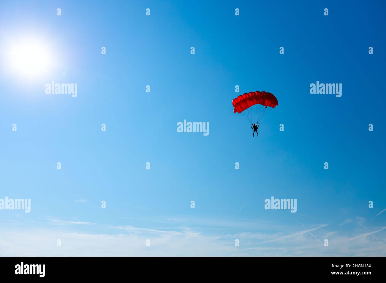 Parachutist is flying slowly down with an open parachute. Skydiving ...