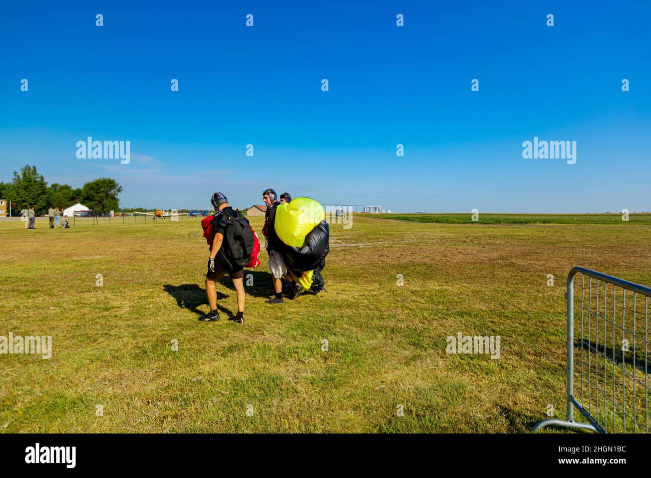 Paratroopers carry opened parachute walk over airfield at National ...