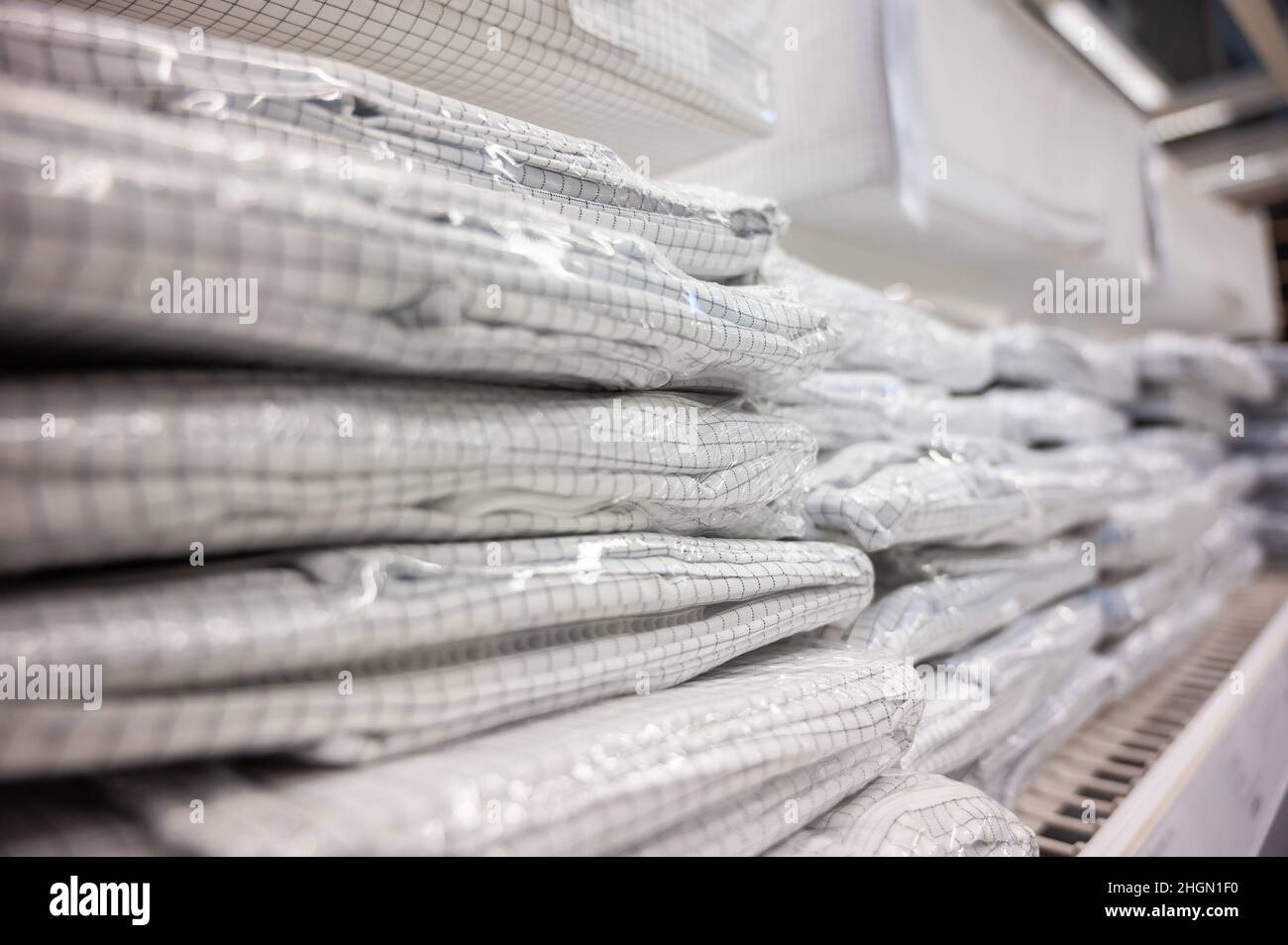 Bed linen in packaging on a shelf Stock Photo - Alamy