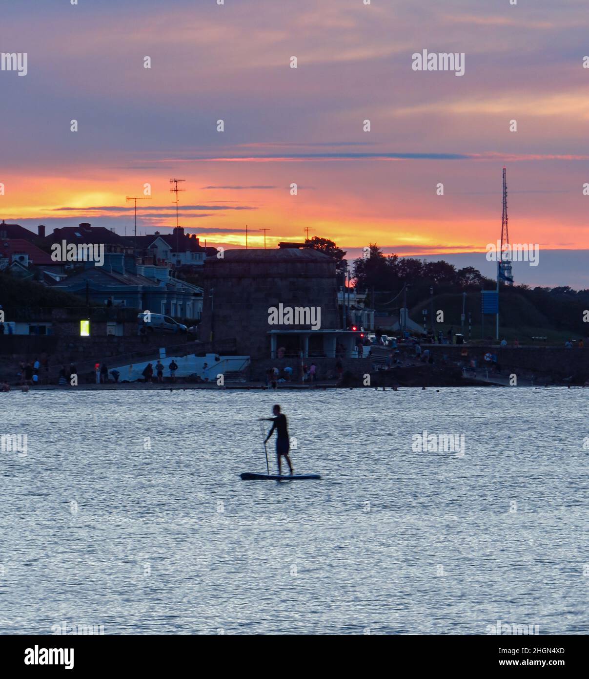 Paddleboarder coming back from his paddle at Seapoint Beach Stock Photo ...