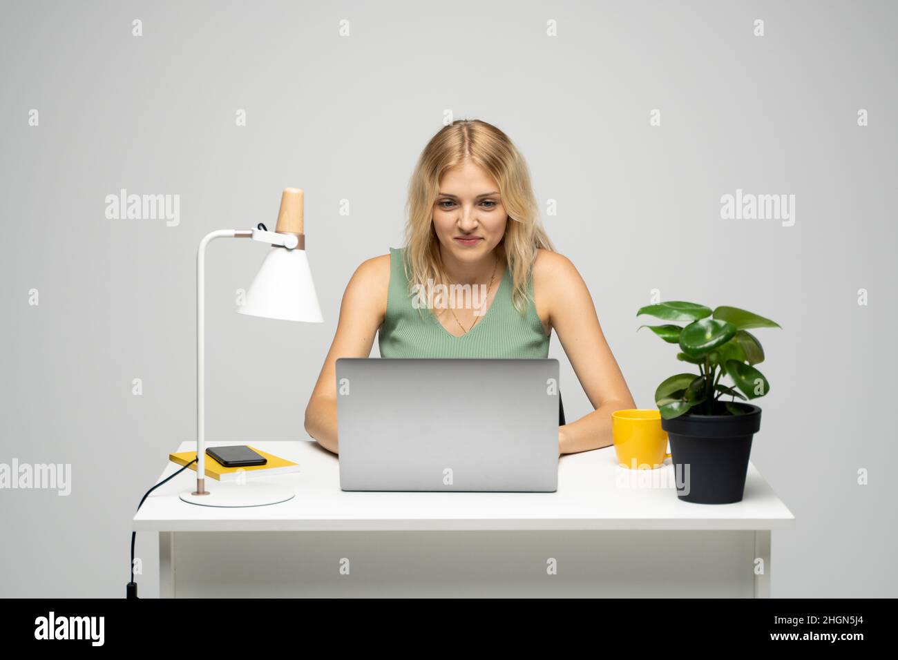Studio portrait of young successful secretary employee business woman ...