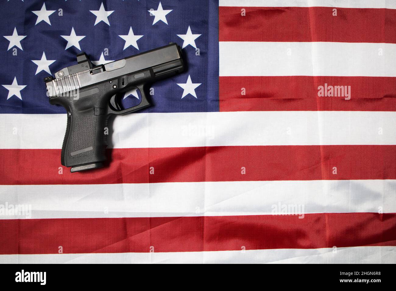 A handgun pistol on the American flag. Gun laws in the USA and self ...