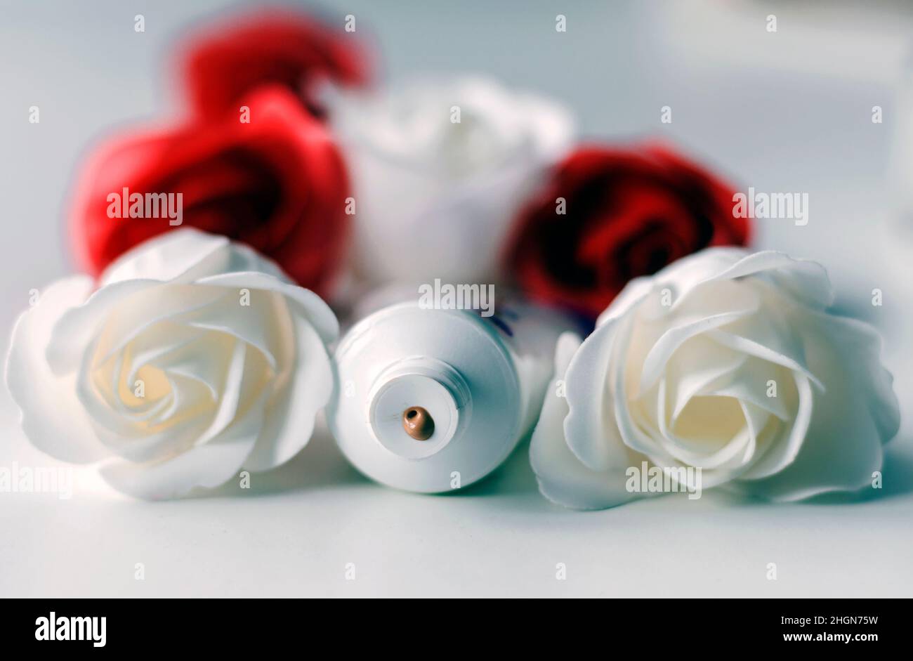 cosmetic product in a tube on a bong background with roses Stock Photo ...