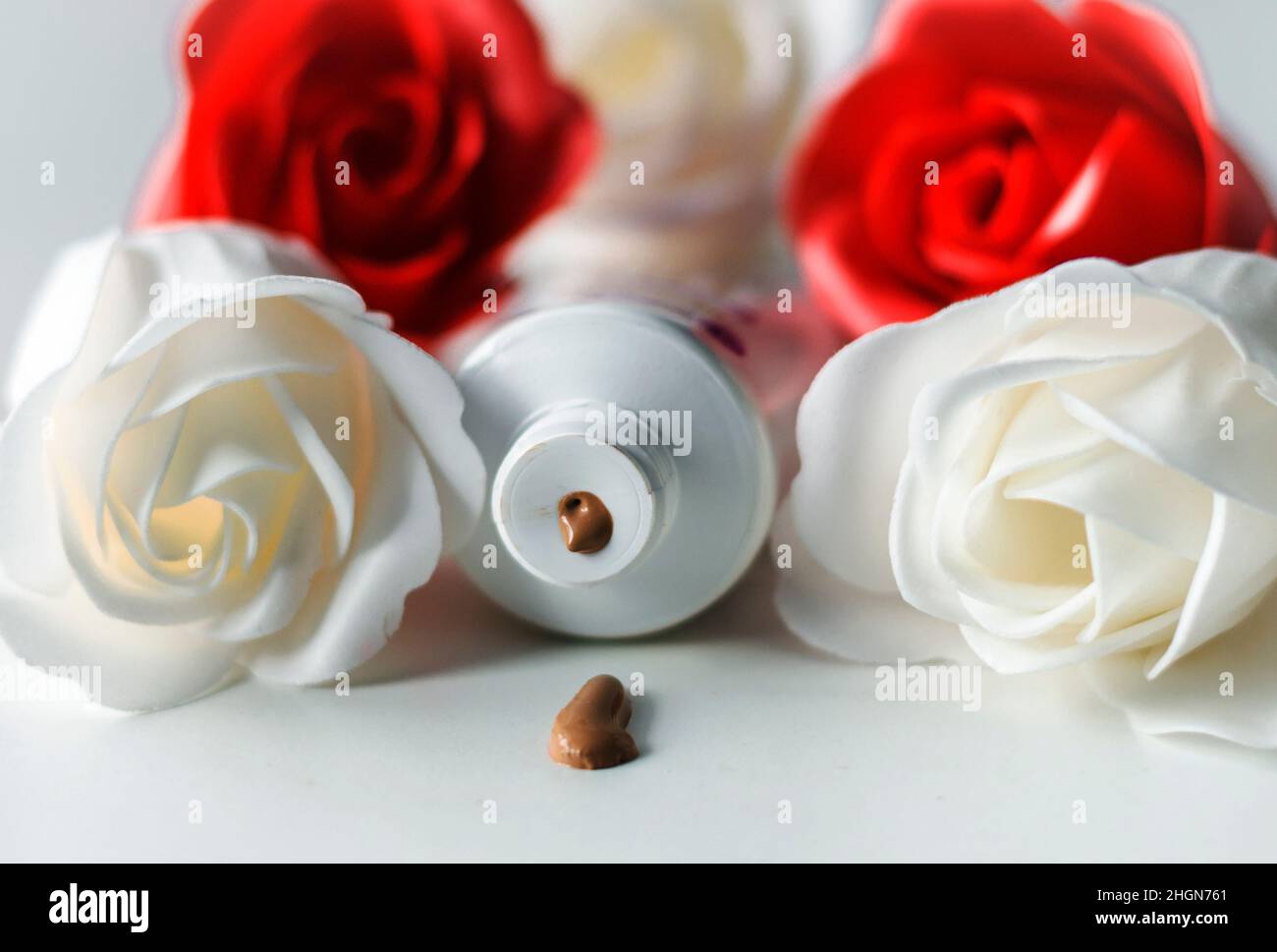 cosmetic product in a tube on a bong background with roses Stock Photo ...
