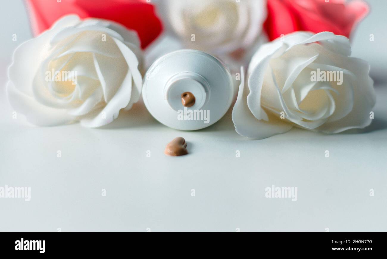 cosmetic product in a tube on a bong background with roses Stock Photo ...