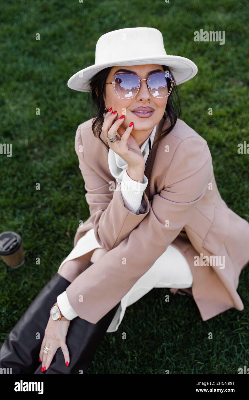 Fashion model weared white posing on the grass. Lifestyle portrait ...