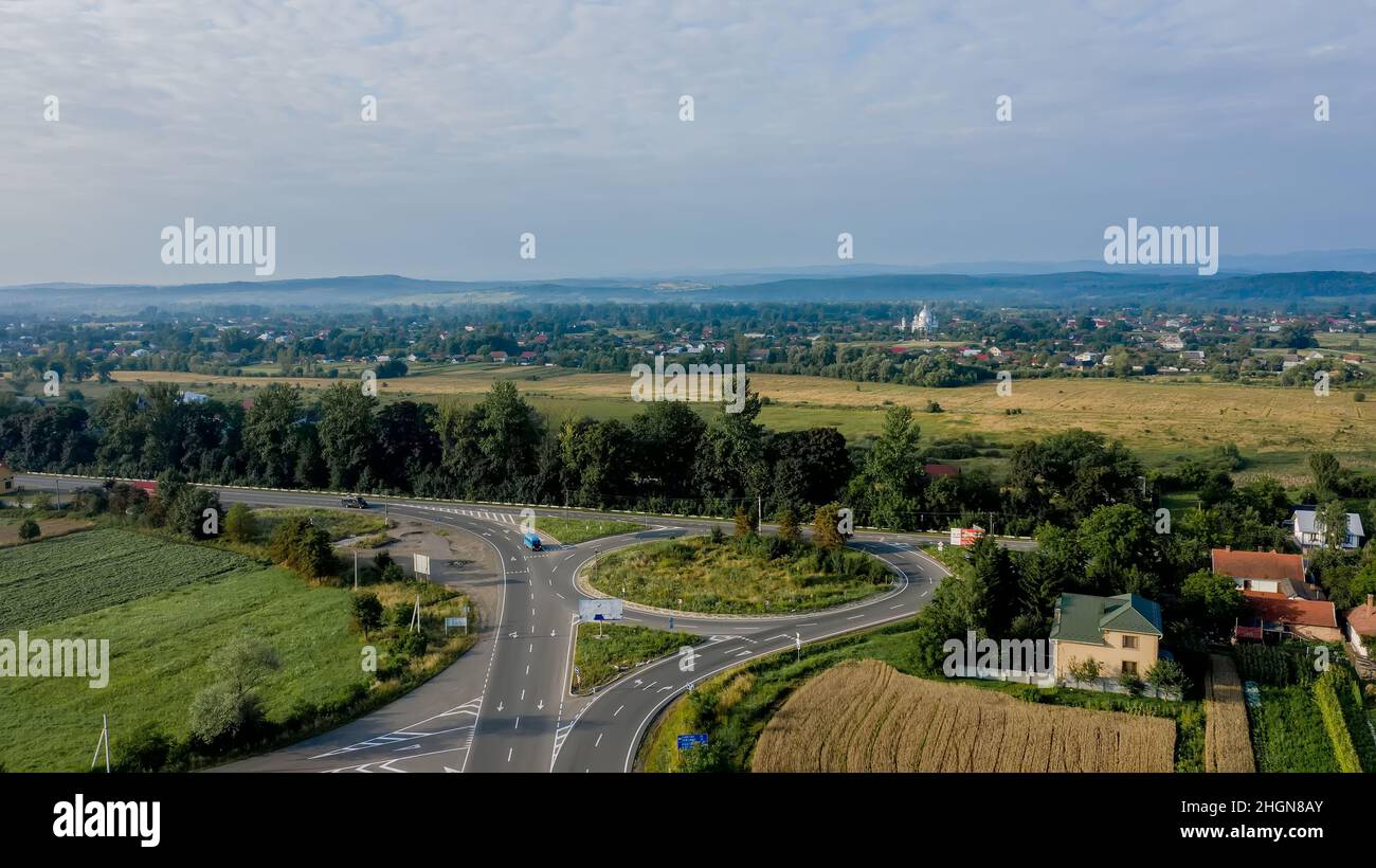 Roundabout traffic of cars and trucks on the circle ring road aerial ...