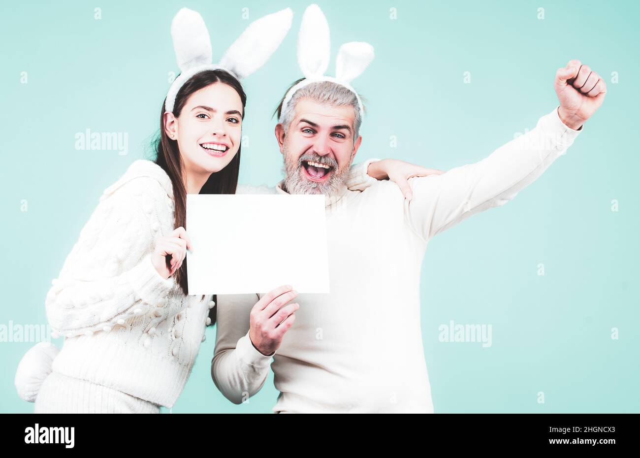 Excited Easter couple in bunny ears and rabbit costume on blue ...