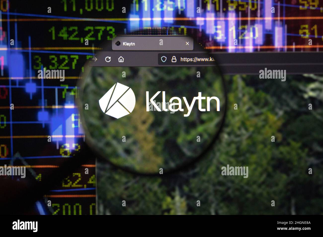 Klaytn crypto company logo on a website, seen on a computer screen through a magnifying glass ...