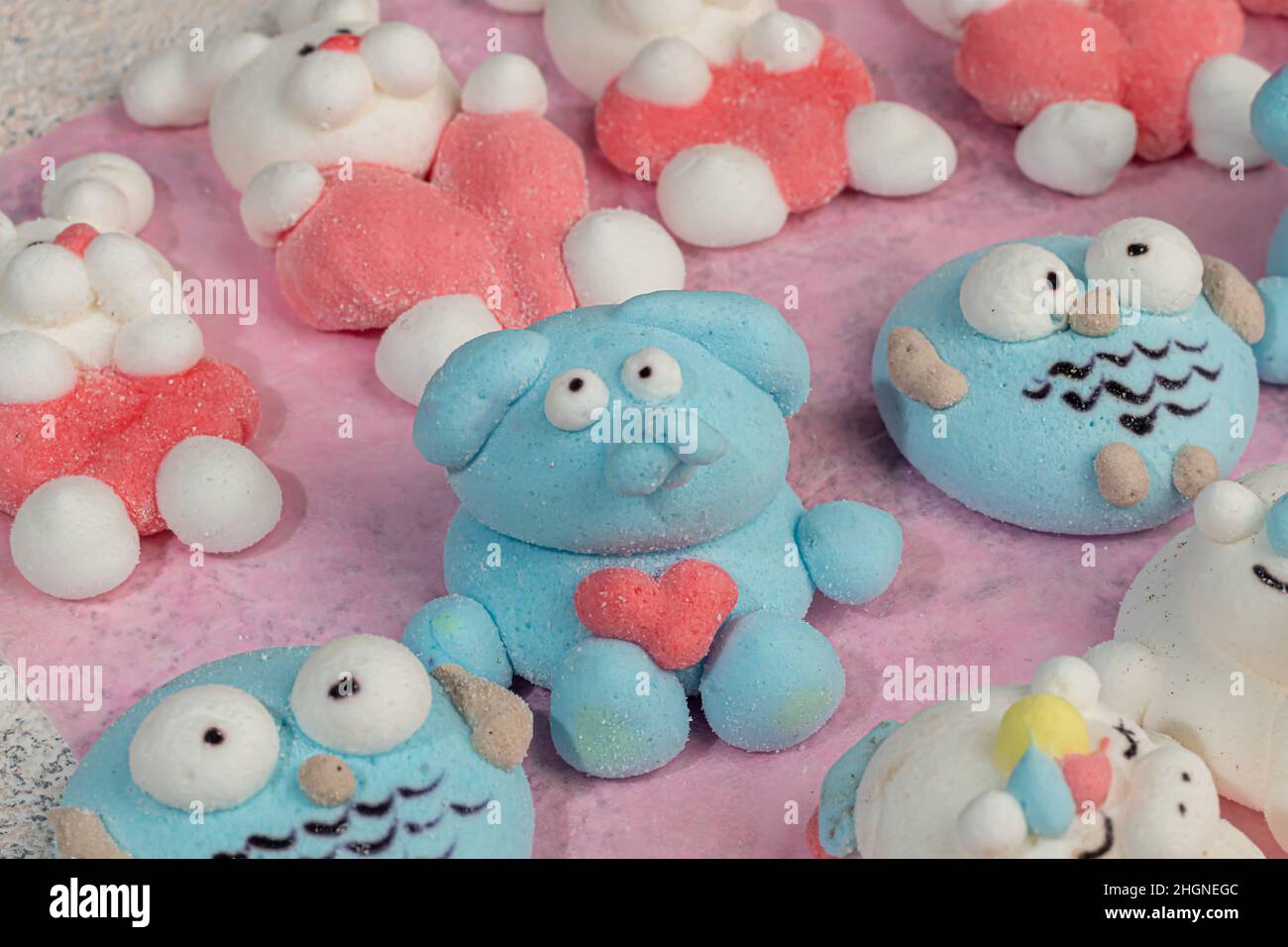 Marshmallow in the form of handmade animals on a light background. In a ...
