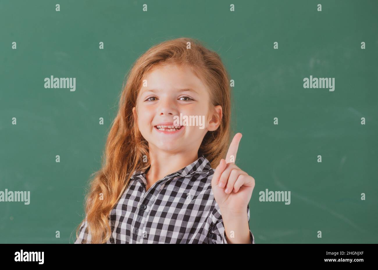Portrait of school girl nerd pupil with surprising expression pointing ...