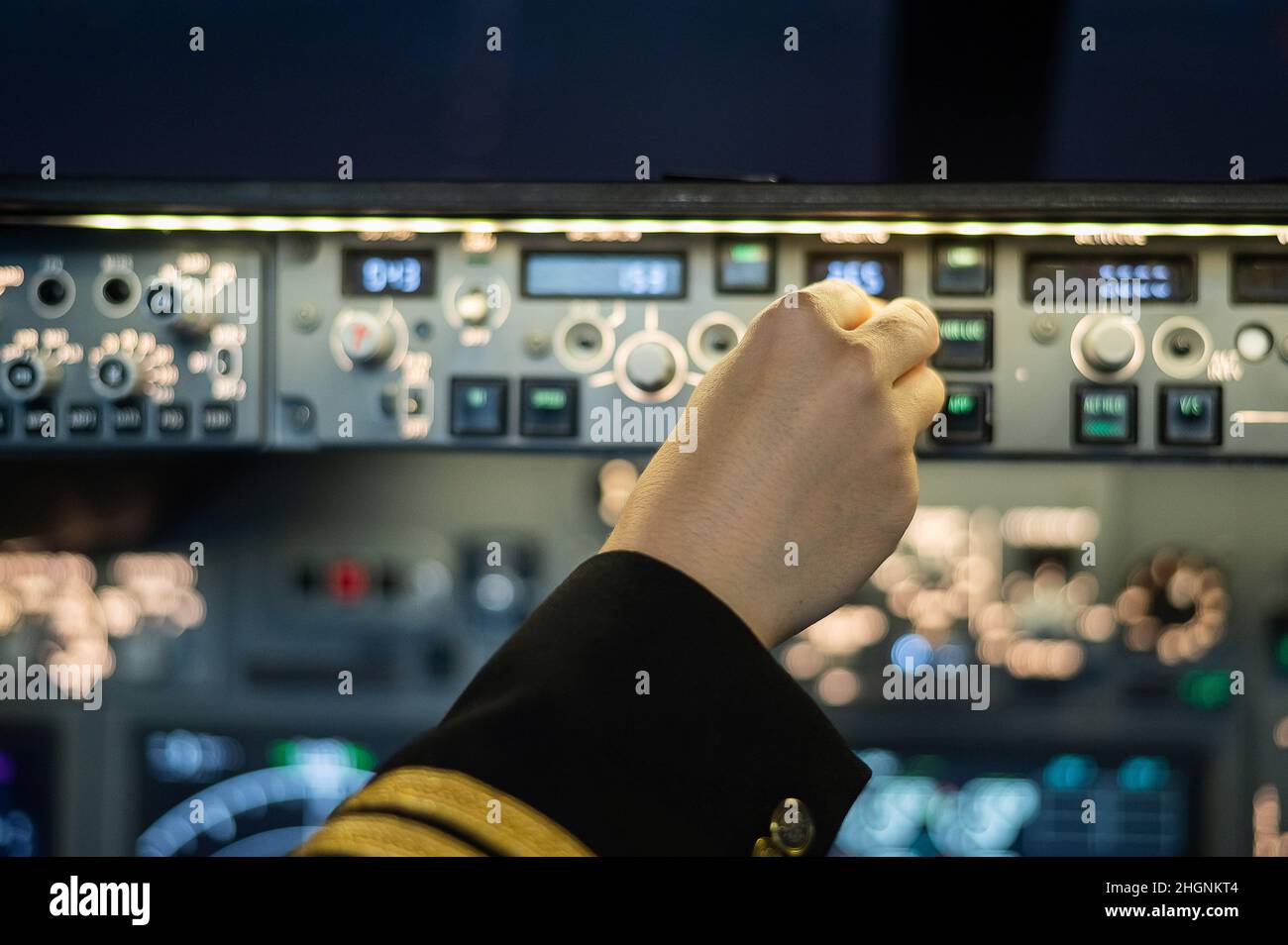 Close-up of a pilot's hand on an airplane control panel Stock Photo - Alamy