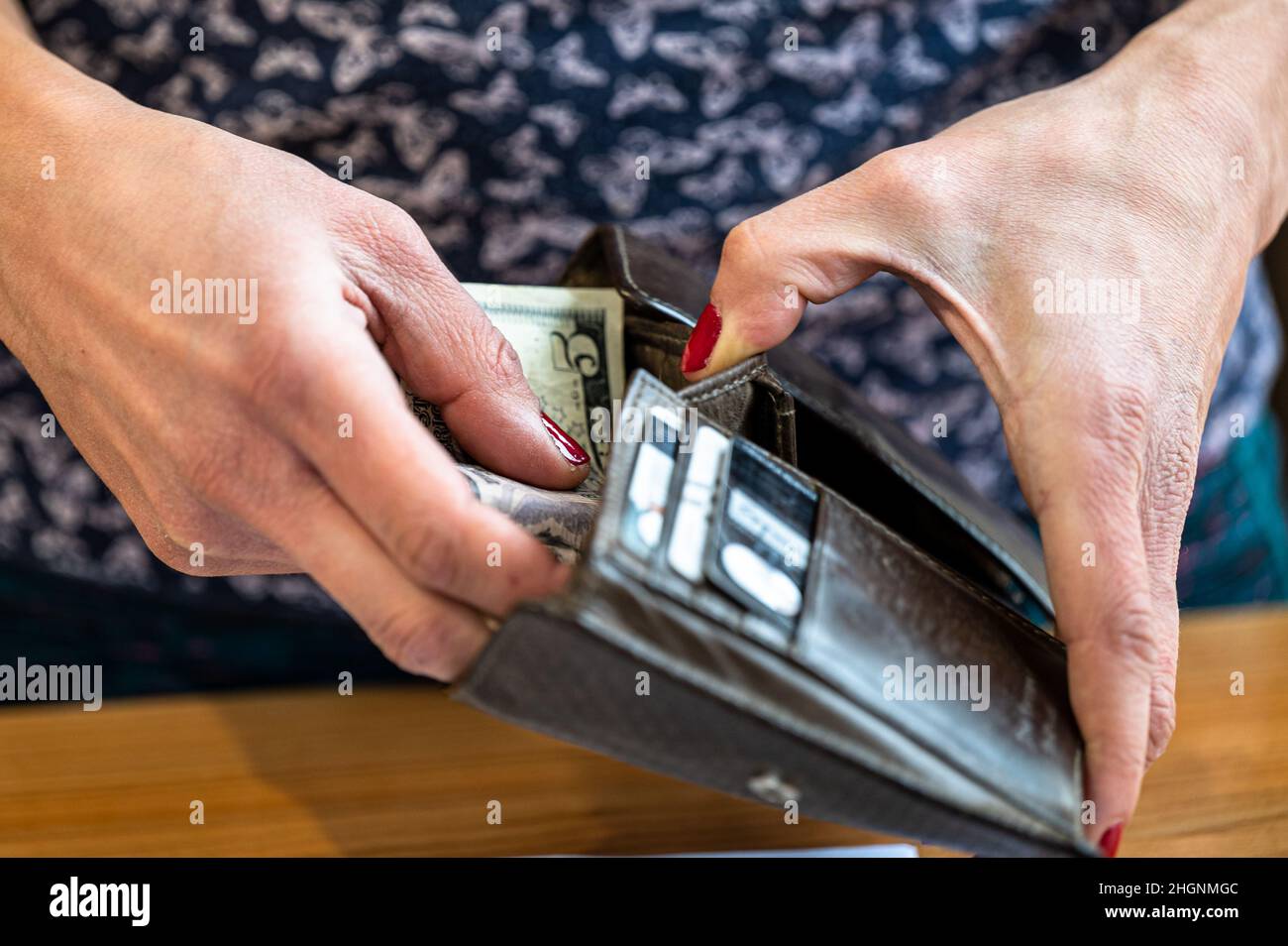 Woman putting money banknote hi-res stock photography and images - Alamy