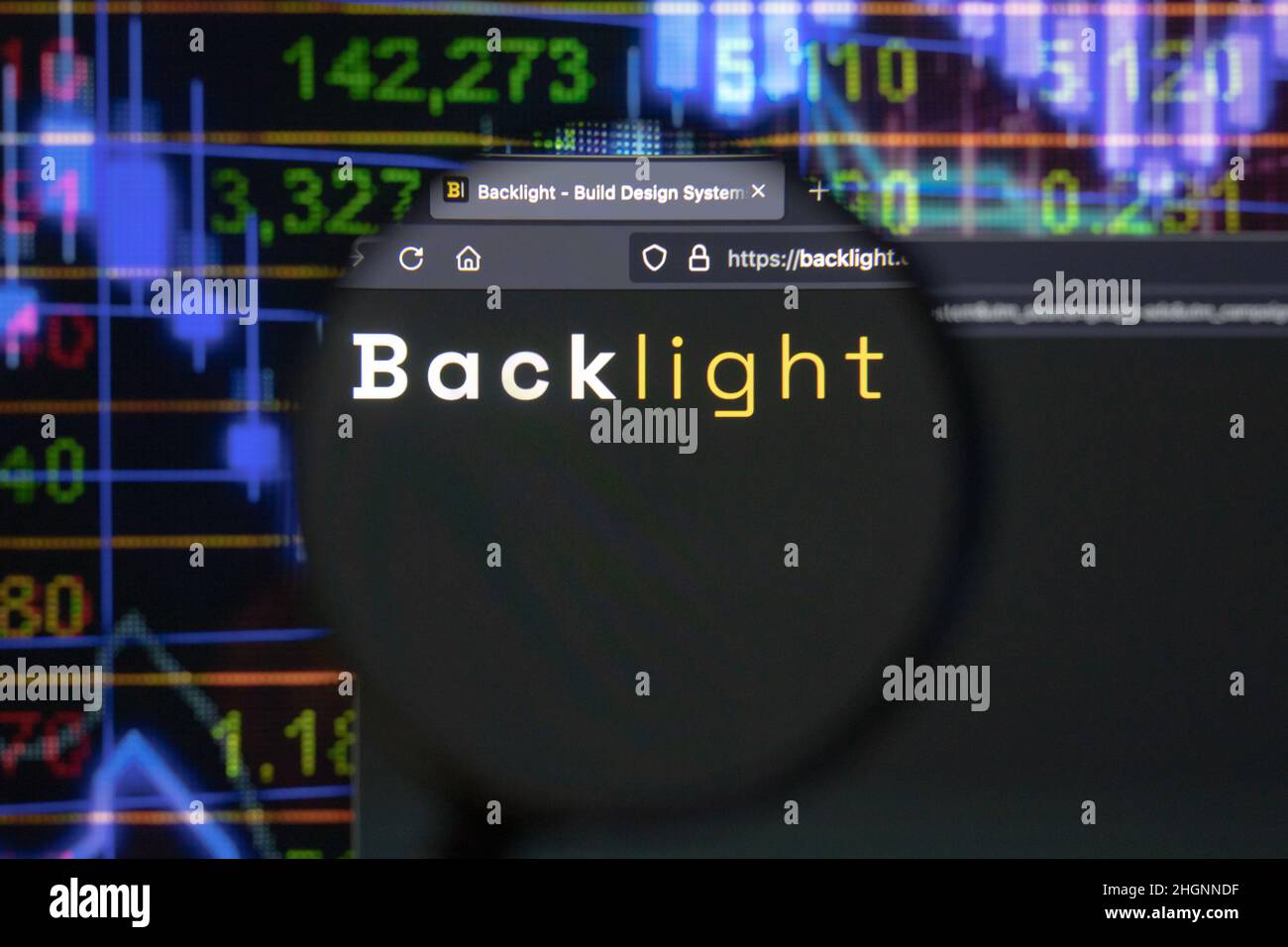 Backlight company logo on a website with blurry stock market ...