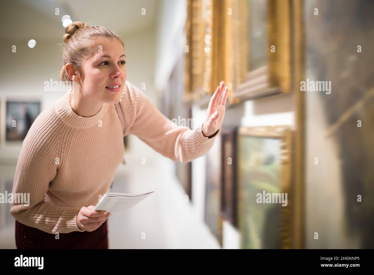 Girl holding book painting hi-res stock photography and images - Alamy