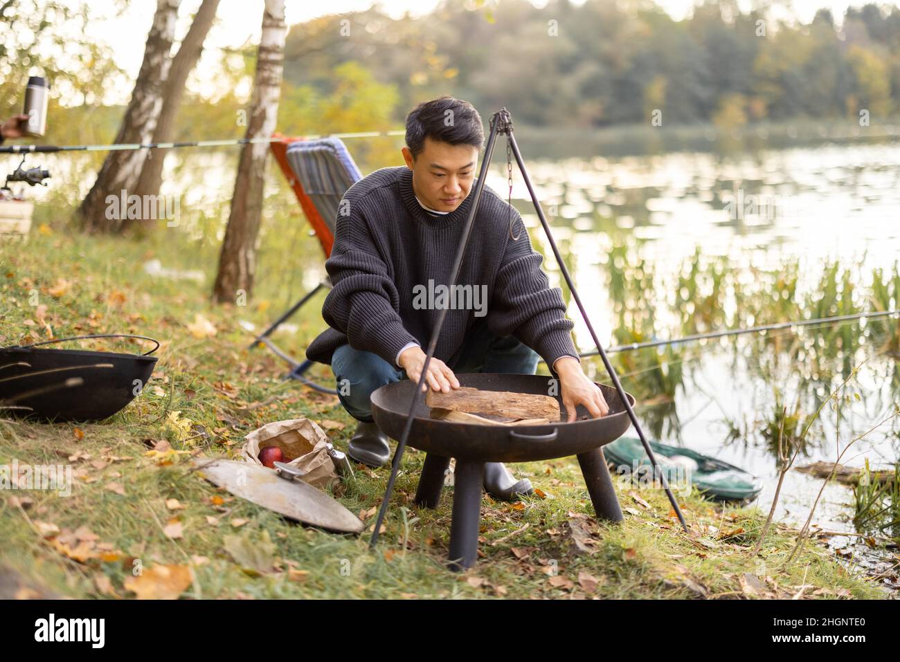 Man making fire in grill for cooking at nature Stock Photo - Alamy
