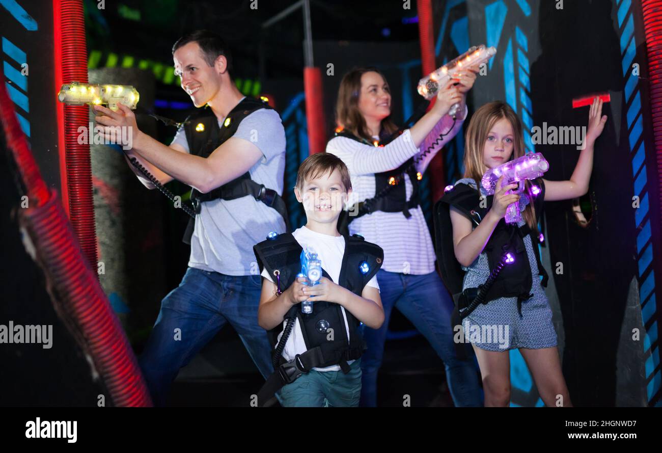 Kids with parents during lasertag game Stock Photo - Alamy