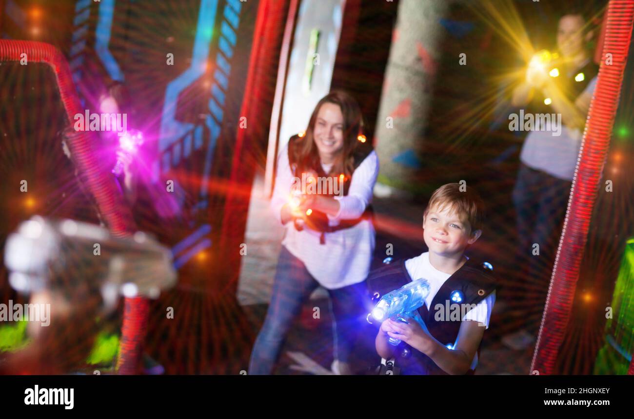 Kids and parents in beams during laser tag game Stock Photo - Alamy