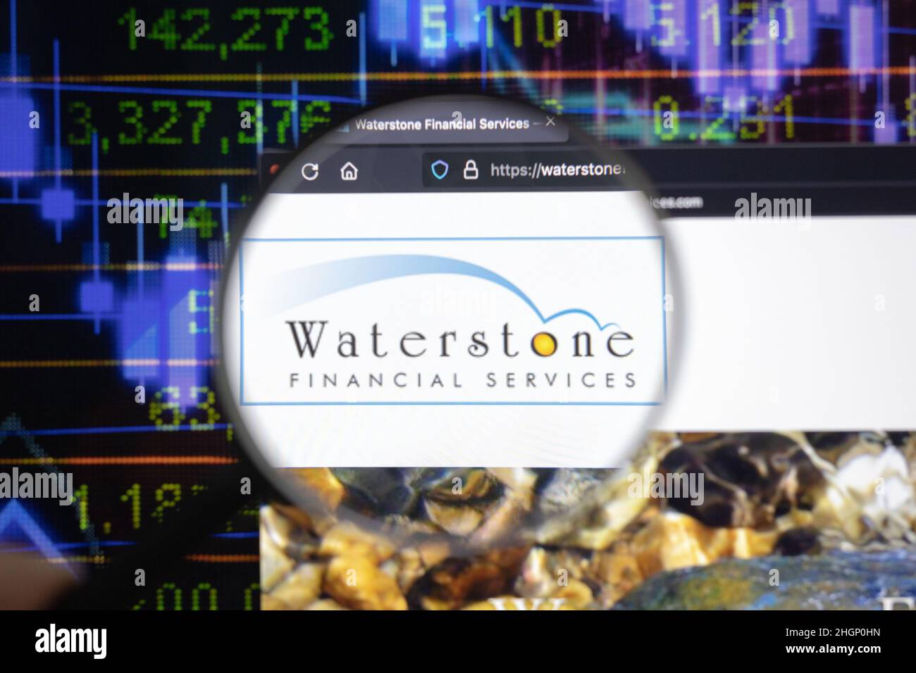 Waterstone Financial Services company logo on a website with blurry stock market developments in ...